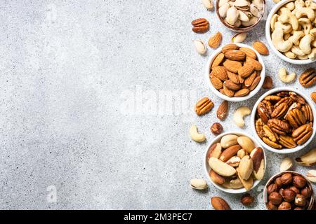 Assortment of nuts in bowls. Cashew, hazelnuts, pecan, almonds ...