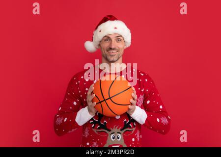Santa trainer hold basketball ball and champion cup. Man in Christmas ...