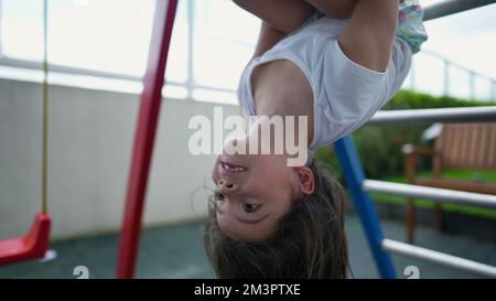 Kid falling from monkey bar child hanging upside down falls down to the ground Stock Photo - Alamy
