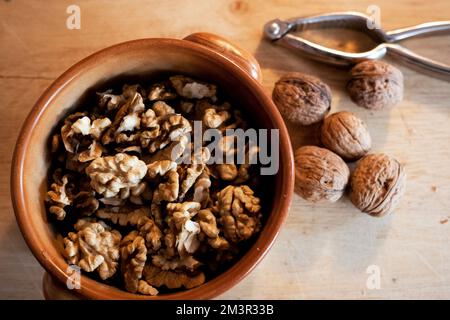 A closeup shot of brown small nuts in the wooden bowl Stock Photo - Alamy