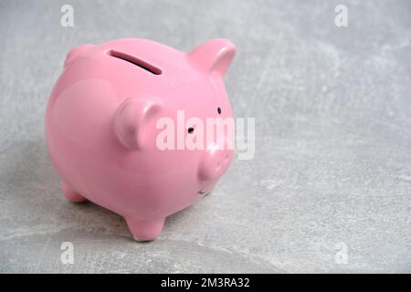 Pink piggy bank light concrete background Stock Photo - Alamy