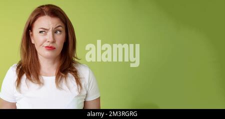 Perplexed doubtful unsure redhead wife smirking unsatisfied frowning ...