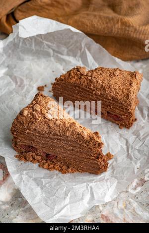 Napoleon cake with custard is decorated with cherries and grated ...