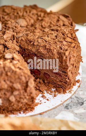 Napoleon cake with custard is decorated with cherries and grated ...