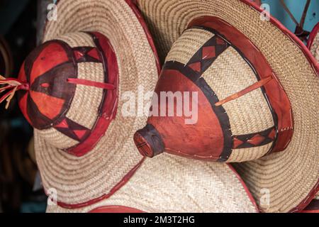 Typical colorful hats of Nigerian Fulani tribe, exposed in touristic ...