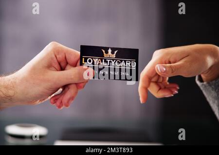 Businessman's Hand Giving Loyalty Card To His Partner Stock Photo - Alamy