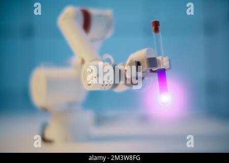 Robotic arm holding test tube Stock Photo - Alamy