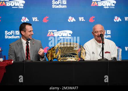 Washington State head coach Jimmy Rogers talks with an official during ...