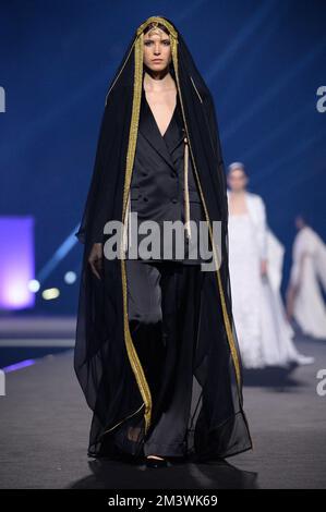A model walks the runway during the Qatar Fashion United by CR at 974 ...
