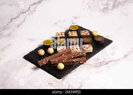 a variety of chocolates on a light background Stock Photo - Alamy