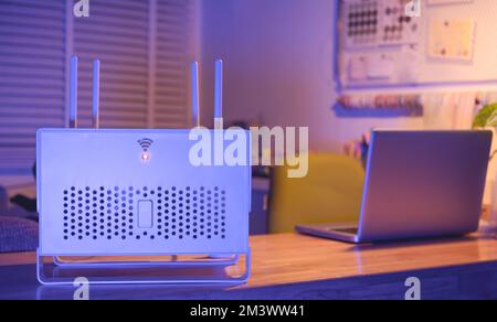 closeup of a wireless router and Laptop computers on living room at ...