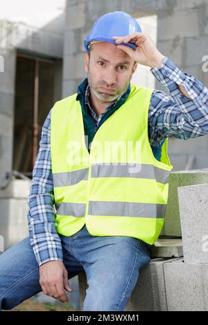 Exhausted worker or craftsman on the construction site sleeps on the ...