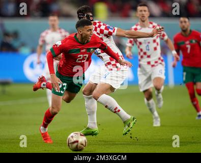 Morocco's Bilal El Khannouss, left, and Noussair Mazraoui jump over ...