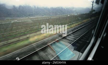 Window perspective of railroad passing by high speed train. Traveling ...
