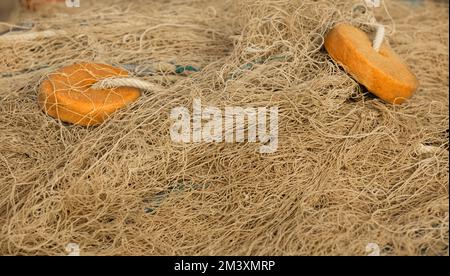 longline fishing net, sand color with red orange and yellow details ...