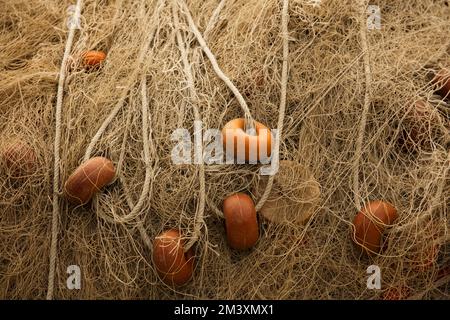 longline fishing net, sand color with red orange and yellow details ...