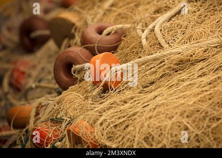 longline fishing net, sand color with red orange and yellow details ...