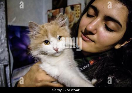 Portrait of Manushak affectionately posing with her cat in a combat ...