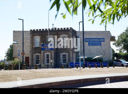 The Waterguard Public House, Cardiff Bay with man on electric ...