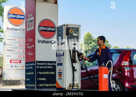 Indian petrolstation with worker serving fuel Stock Photo - Alamy