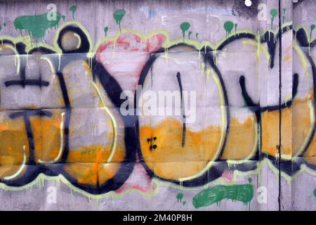 Graffiti word ARCHI OMEN, drawn by a lapdog in white, yellow letters ...