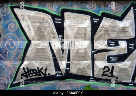 Graffiti word MENOR, drawn by a lapdog in grey, black letters with an ...