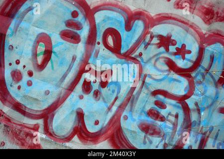 White, blue letters with red dashes, dots, circles, and lines with ...