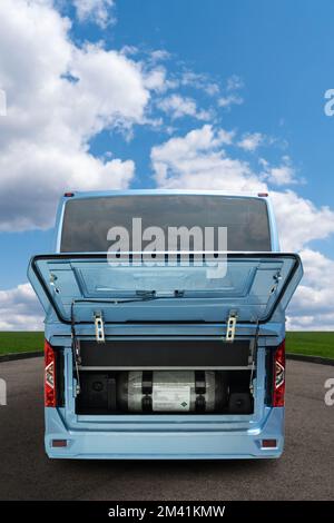 A hydrogen fuel cell bus with an open hood and a hydrogen tank inside ...