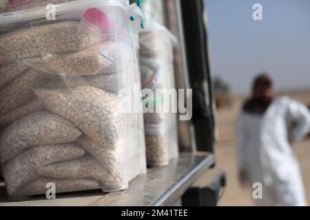 Baghdad, Iraq. 18th Dec, 2022. Workers dump narcotic pills before the ...