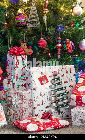 Beautifully wrapped gift boxes under Christmas tree indoors Stock Photo ...