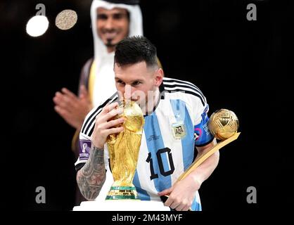 Argentina's Lionel Messi kisses the FIFA World Cup trophy after being ...