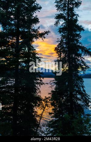 Colorful sunset reflects in Dease Lake; British Columbia; Canada Stock ...