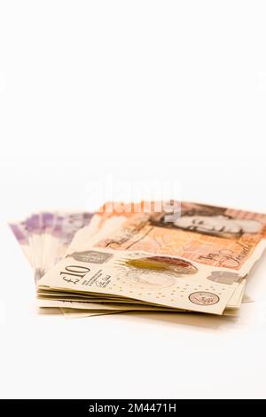 a detailed close-up of new fanned plastic GBP £ Sterling 10 Ten and 20 ...