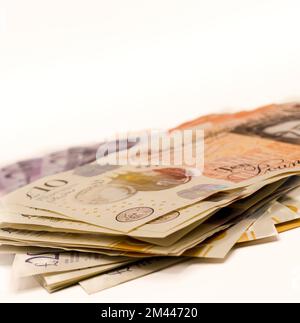 a detailed close-up of new fanned plastic GBP £ Sterling 10 Ten and 20 ...