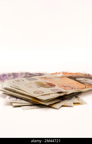 a detailed close-up of new fanned plastic GBP £ Sterling 10 Ten and 20 ...