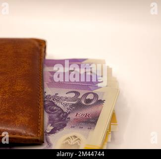 a light brown leather wallet with bank cards and a detailed close-up of ...