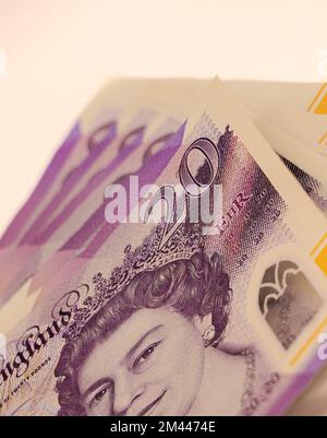 a detailed close-up of new fanned plastic GBP £ Sterling 10 Ten and 20 ...