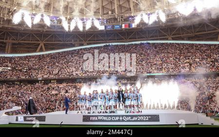 Lusaier, Qatar. 18th Dec, 2022. Lionel Messi (R) holds the FIFA World ...
