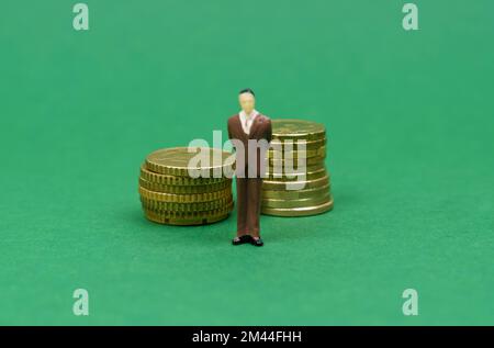Economic concept. Miniatures. On the green surface is a pack of dollars ...