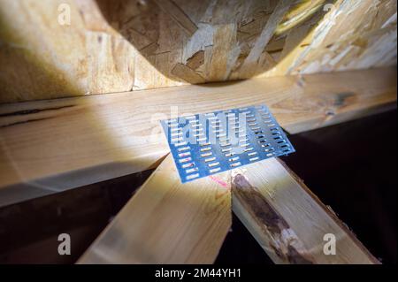 Rafter galvanized mending nail plate in an attic connecting a joint ...