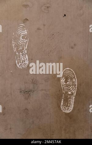 Stop sign with footprints on pavement at Poole, Dorset UK in May ...
