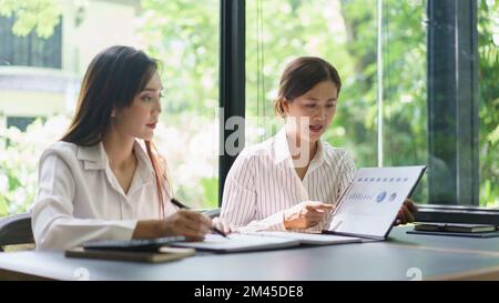 Coworker business concept, Businesswoman hold chart document to ...