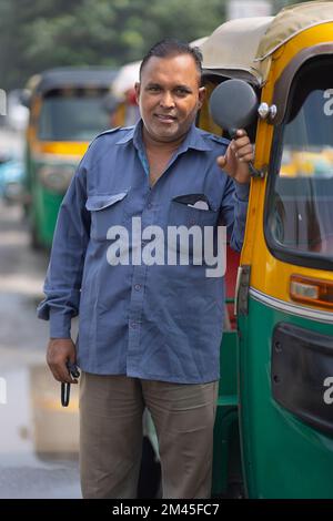 Portrait of an auto rickshaw driver standing in auto stand Stock Photo ...