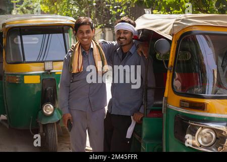 Portrait of happy auto drivers standing at auto stand Stock Photo - Alamy