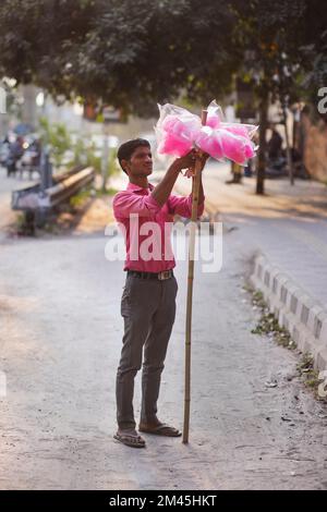Male vendor selling cotton candy on the street Stock Photo - Alamy