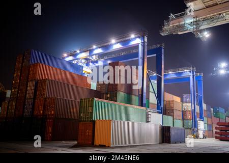 stacks of containers. operation of container terminal at night ...