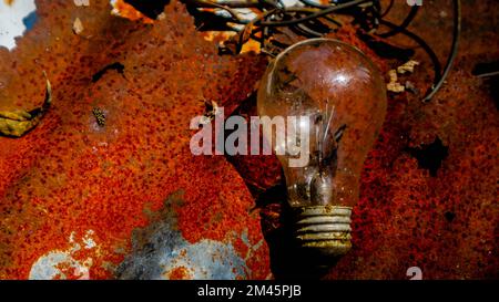 Light bulb on rusty zinc as background Stock Photo - Alamy