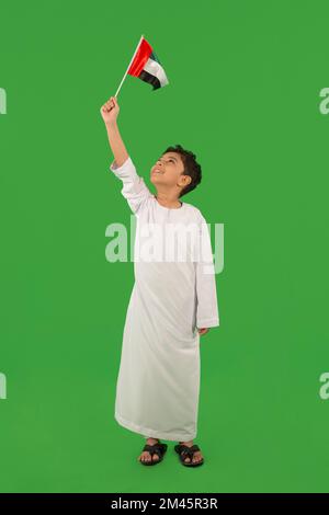 Portrait of an Arab boy holding a UAE national flag Stock Photo - Alamy