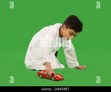 Arab boy pushing toy car Stock Photo - Alamy