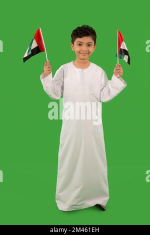Portrait of an Arab boy holding a UAE national flag Stock Photo - Alamy